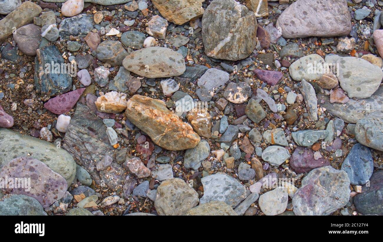 Textural backgrounds of beach pebbles, rocks and sand along the strand ...