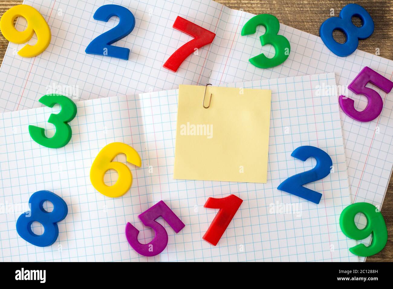 Exercise book with numbers and sticky note Stock Photo - Alamy
