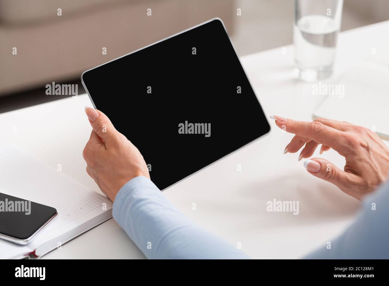 Woman holds tablet during hi-res stock photography and images - Alamy