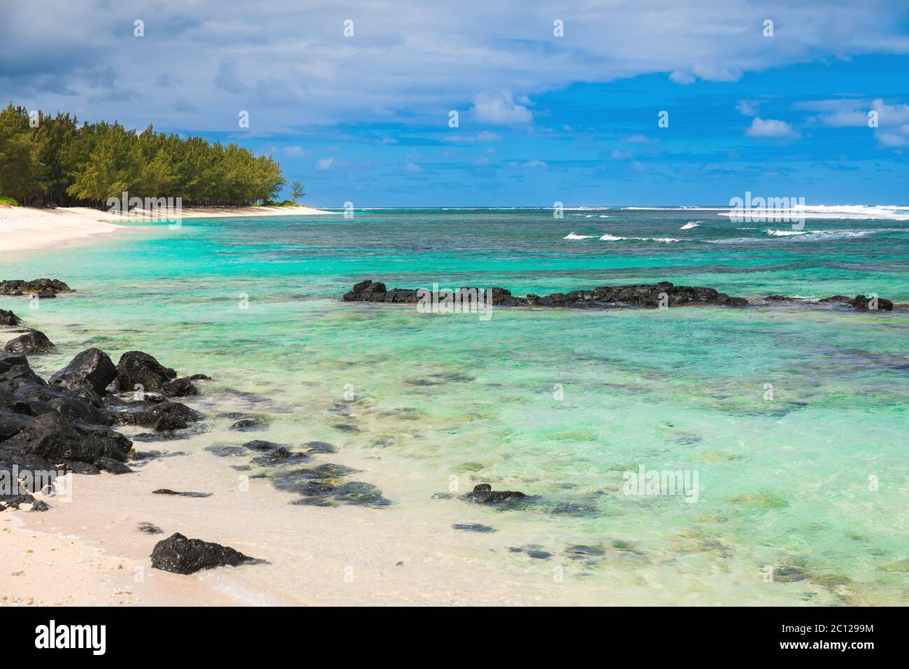 Tropical beach with sand, rocks, transparent ocean and blue sky in ...
