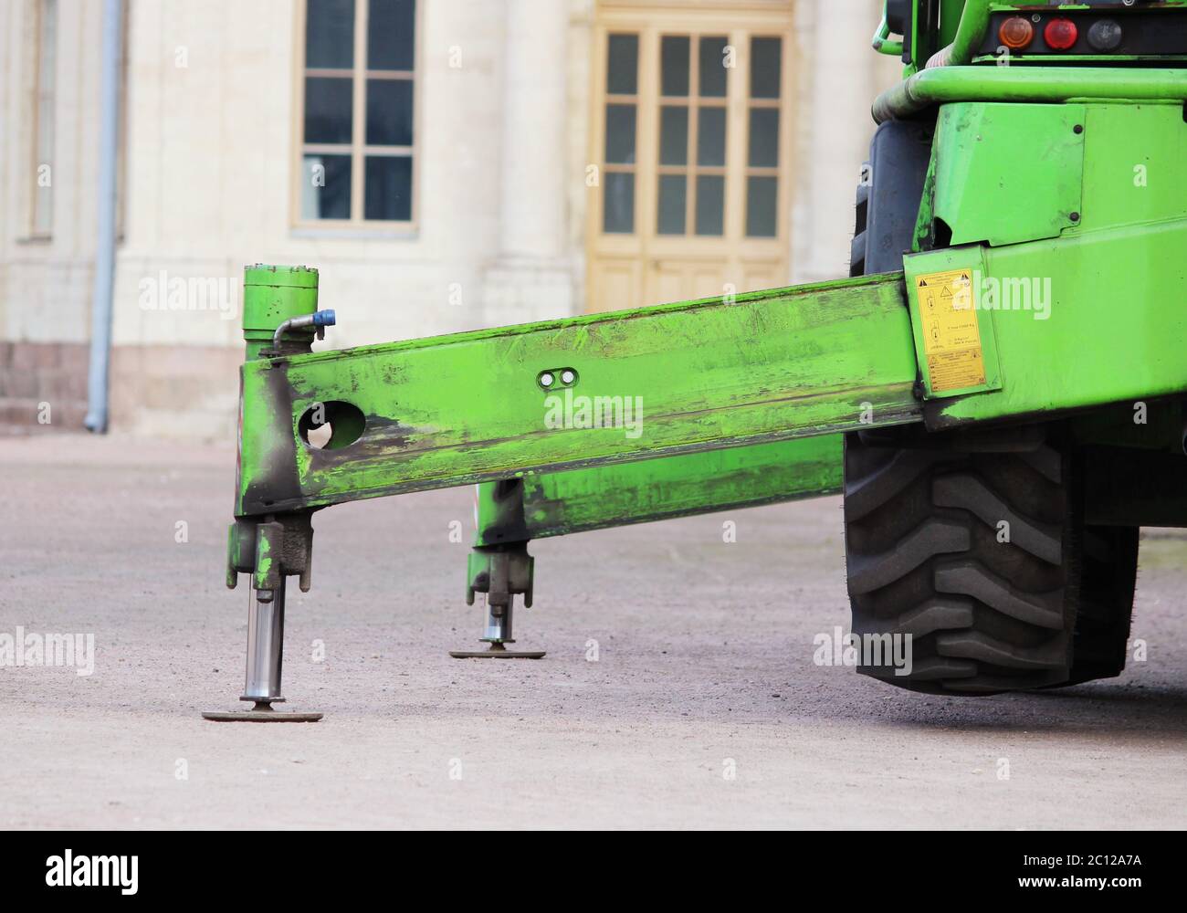 Truck strong outrigger stabilizing legs extended. Boom lifts building ...