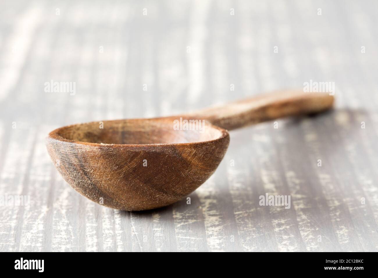 Wooden spoon on the grey background Stock Photo - Alamy