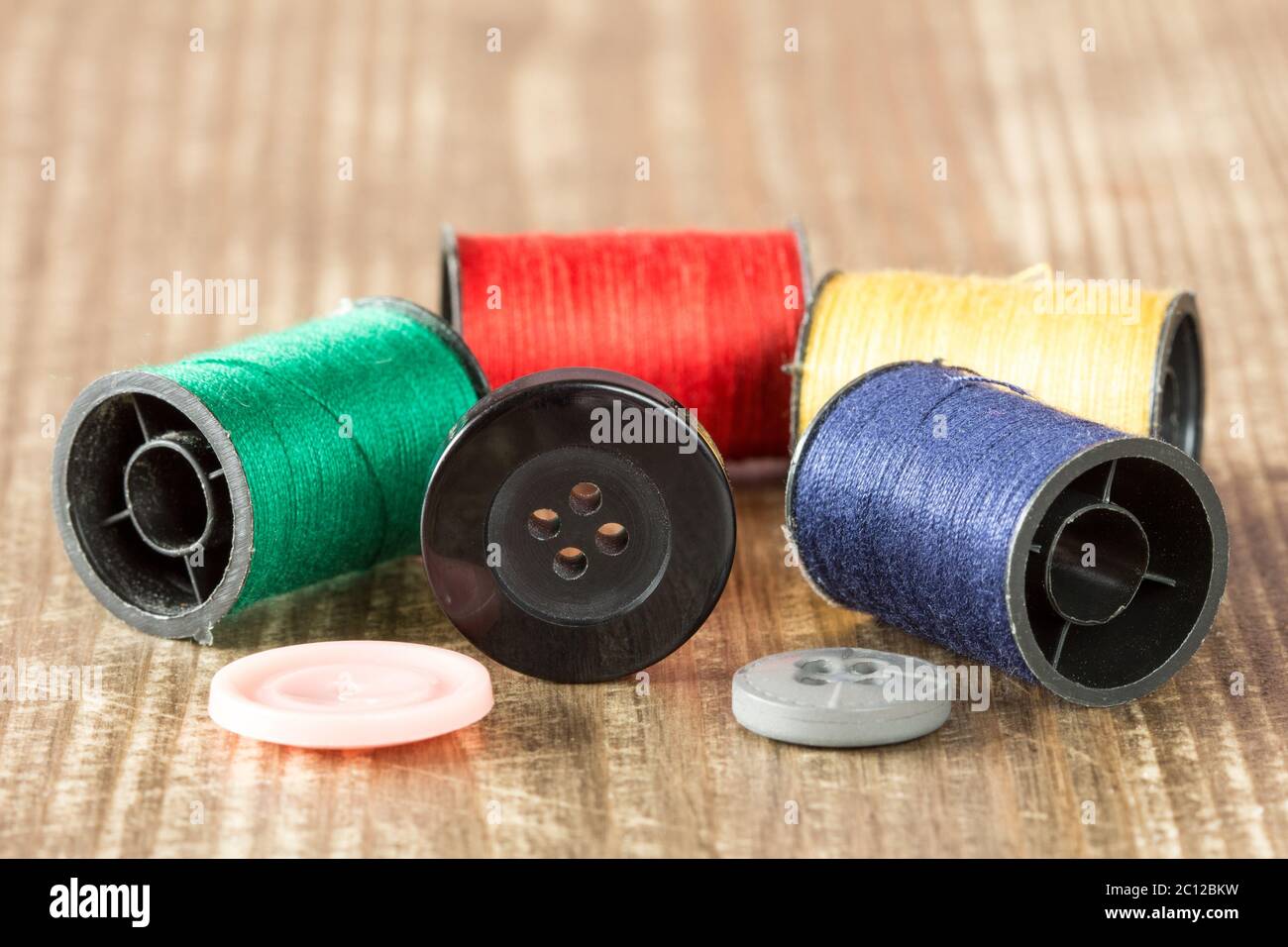 Spools of colored thread and buttons Stock Photo - Alamy