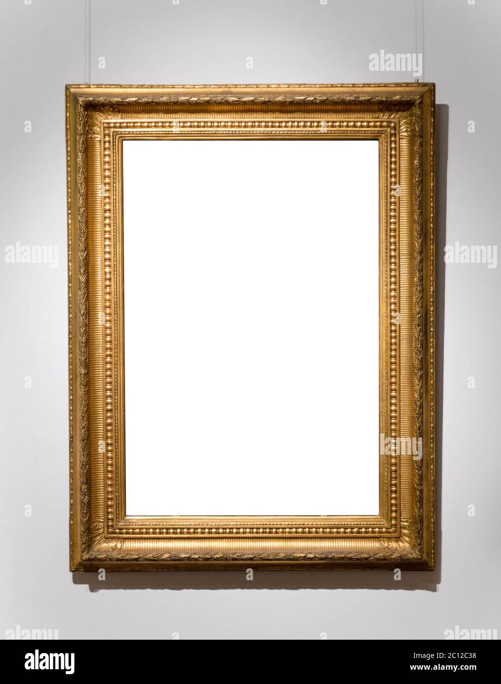 Gold empty frame on white wall Stock Photo - Alamy