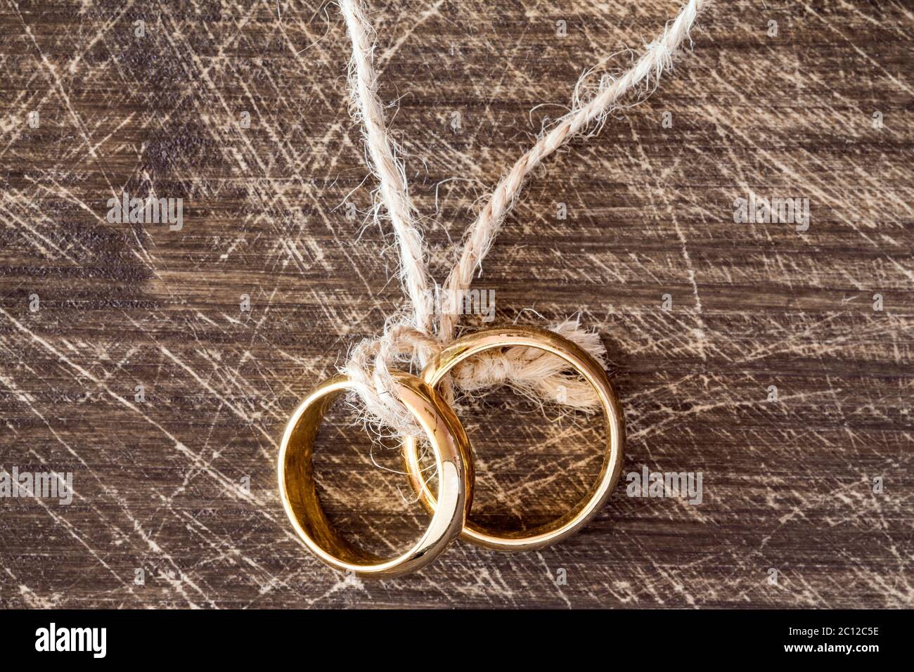 Golden rings hanging on rope Stock Photo - Alamy