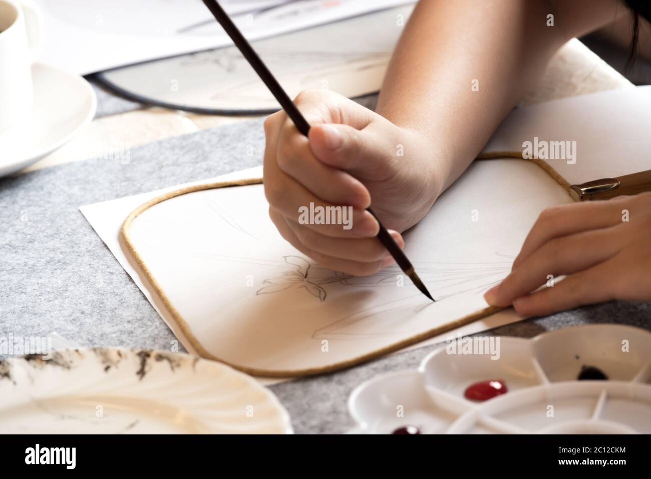 someone drawing on paper fan Stock Photo - Alamy
