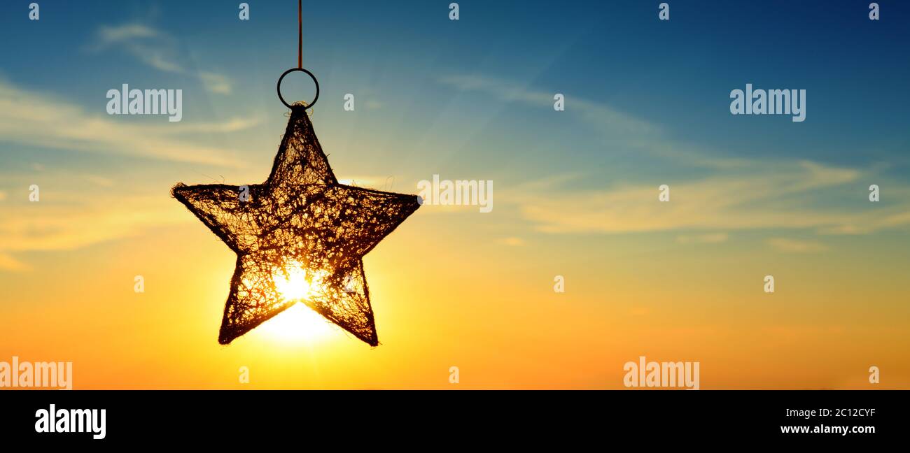 Christmas star and bright sun Stock Photo - Alamy