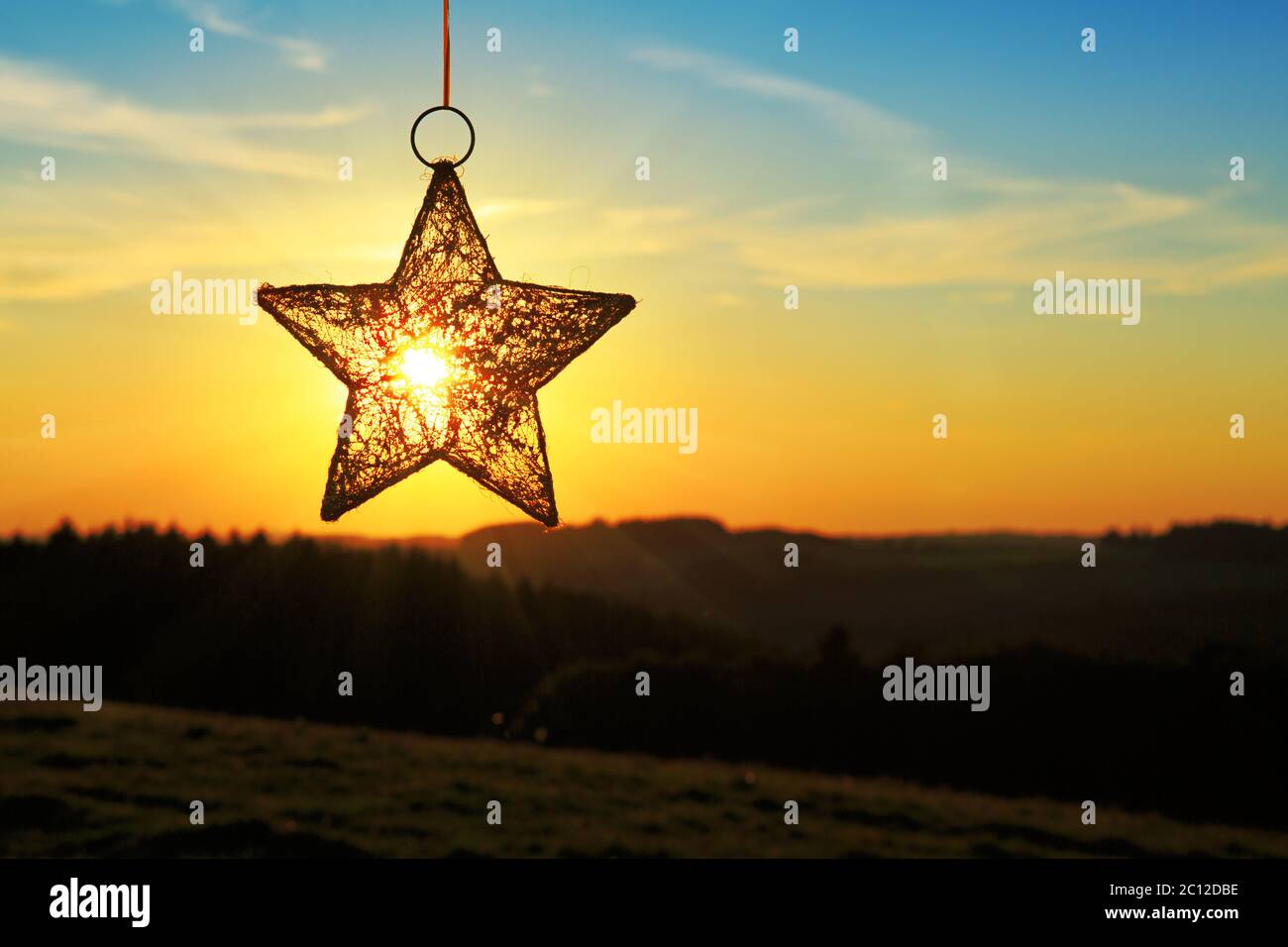 Christmas star and bright sun Stock Photo - Alamy