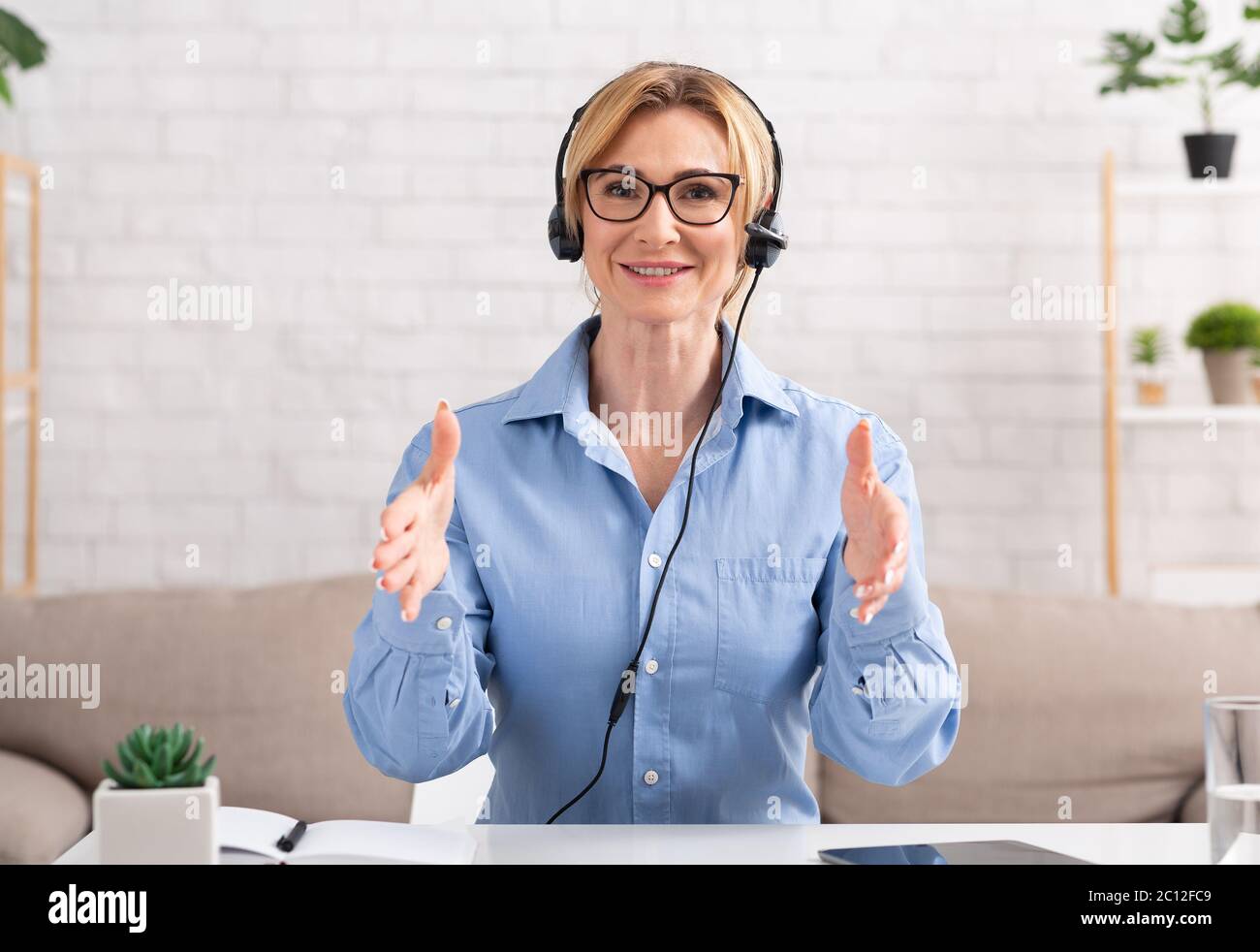 Learning remotely. Professional female tutor giving online language ...