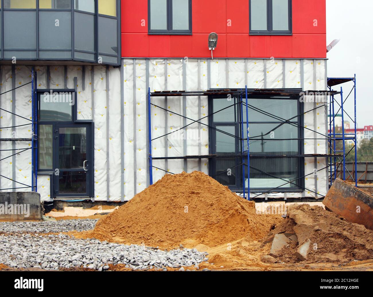 pile of sand and scaffolding at construction site near the under ...
