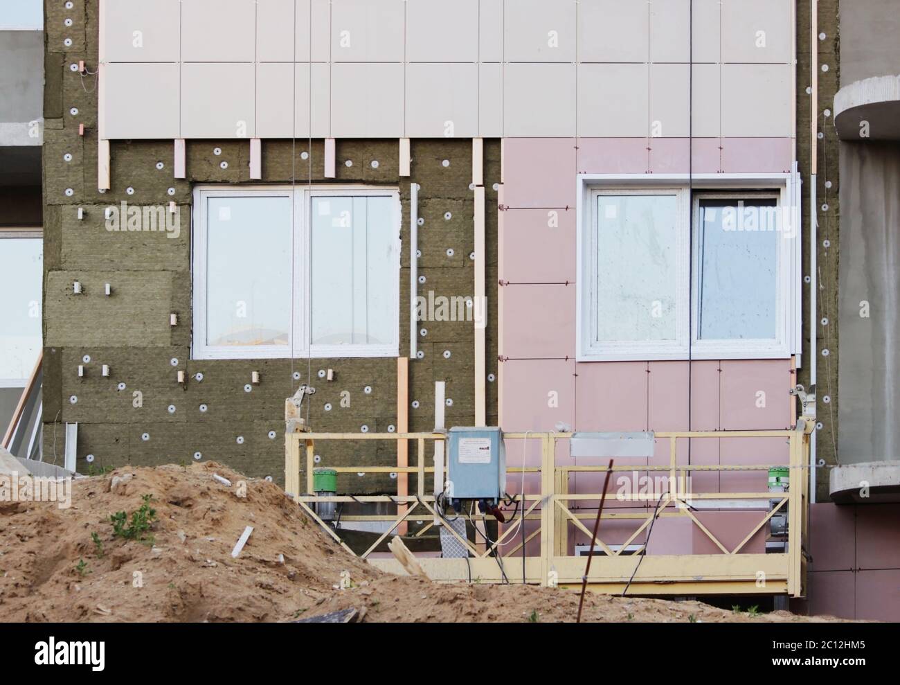 construction suspended yellow cradle without workers on a newly built ...