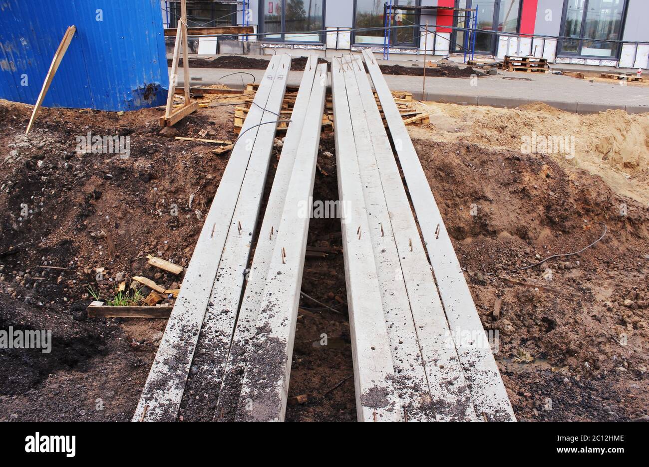 reinforced concrete beams of square section lie on the ground at the ...