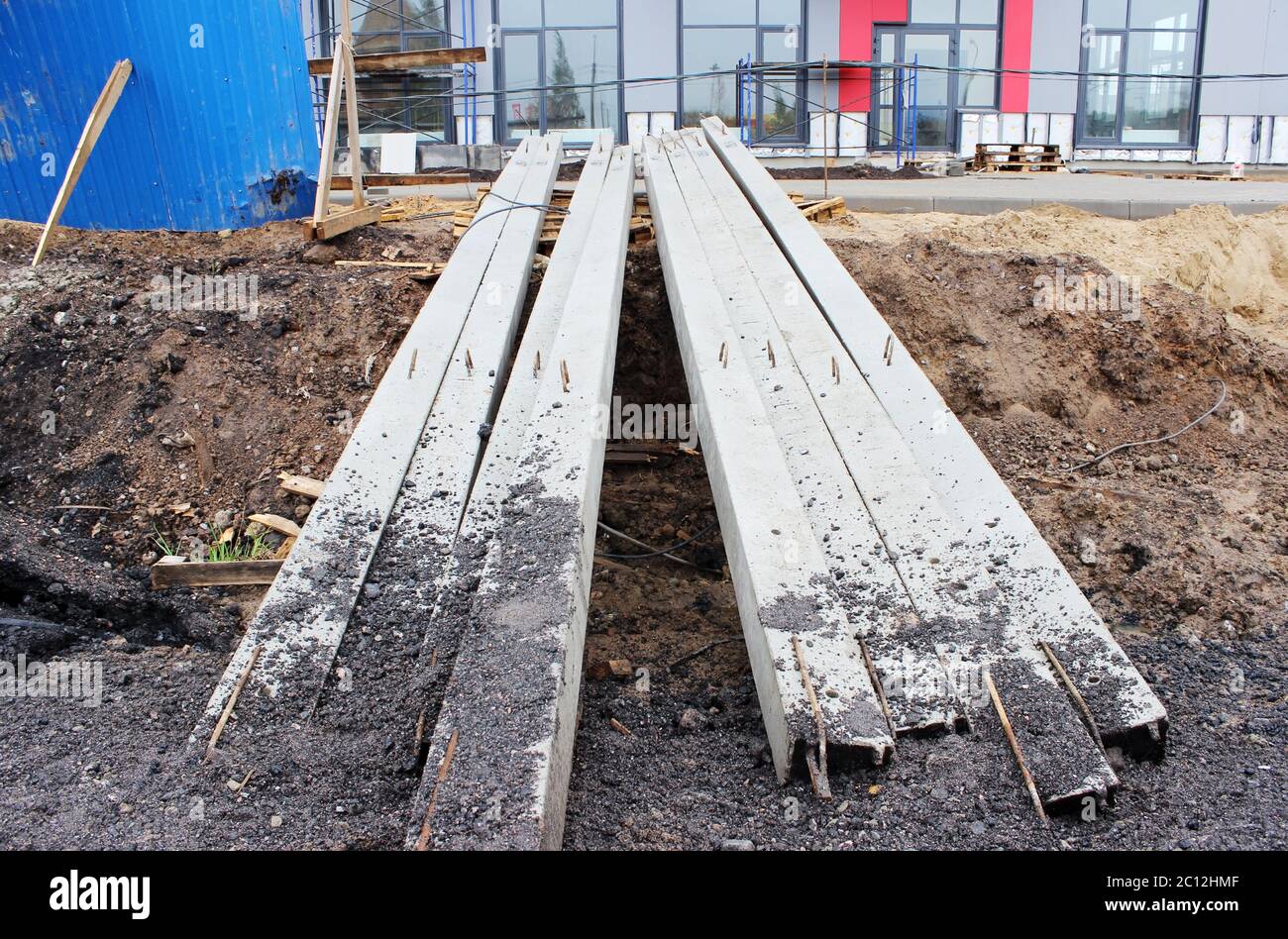 reinforced concrete beams of square section lie on the ground at the ...