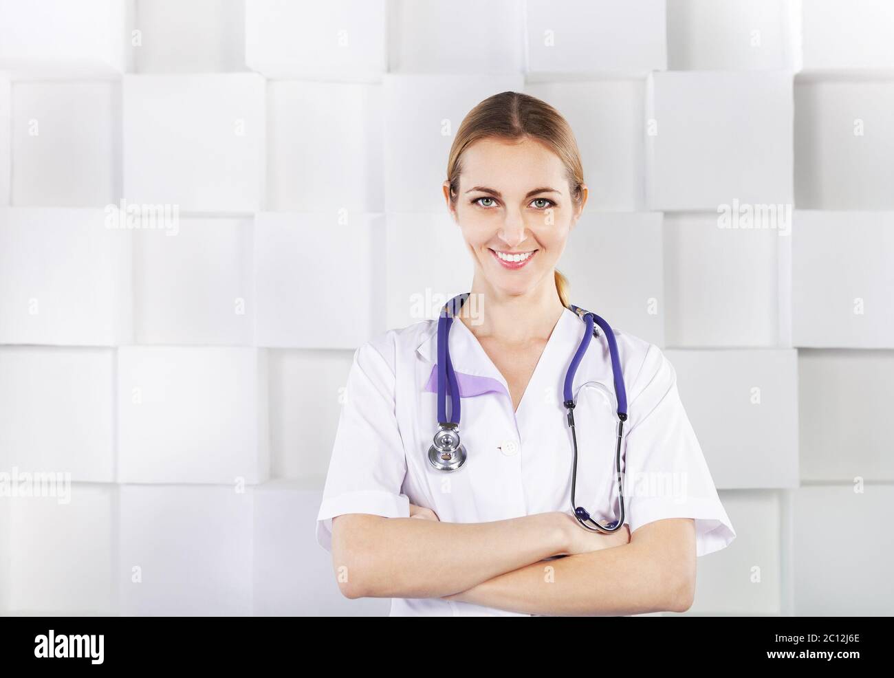 Pretty smiling woman doctor in uniform Stock Photo - Alamy