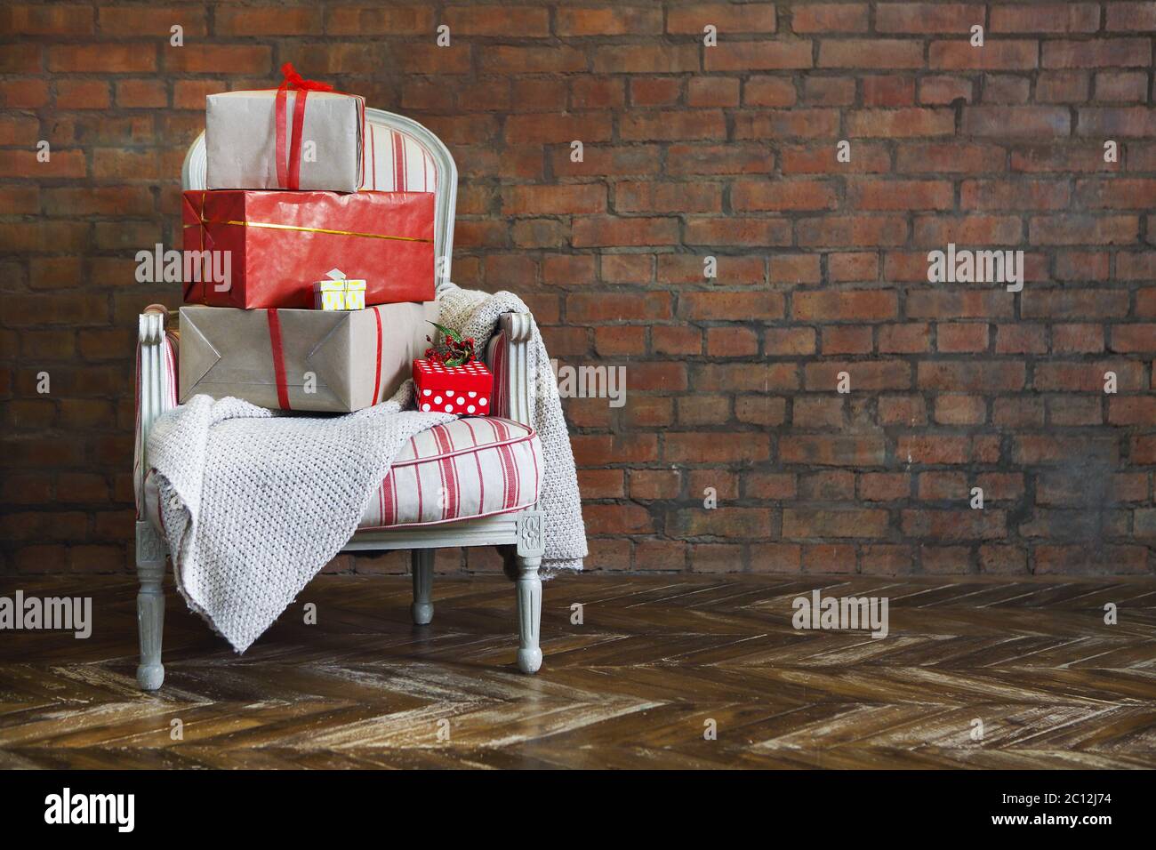 Christmas gifts on armchair Stock Photo - Alamy