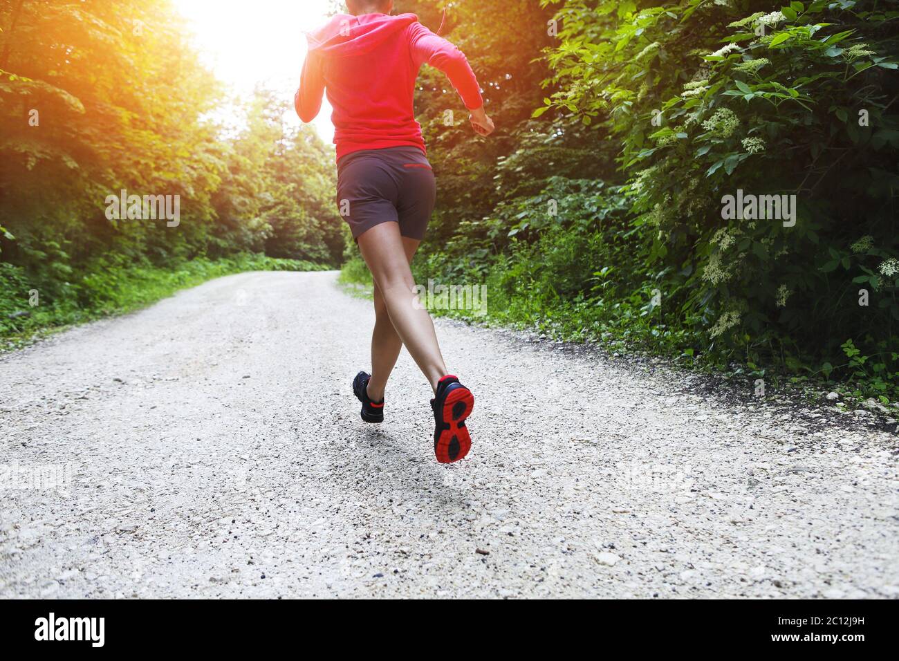Woman jogging on countryside road hi-res stock photography and images ...