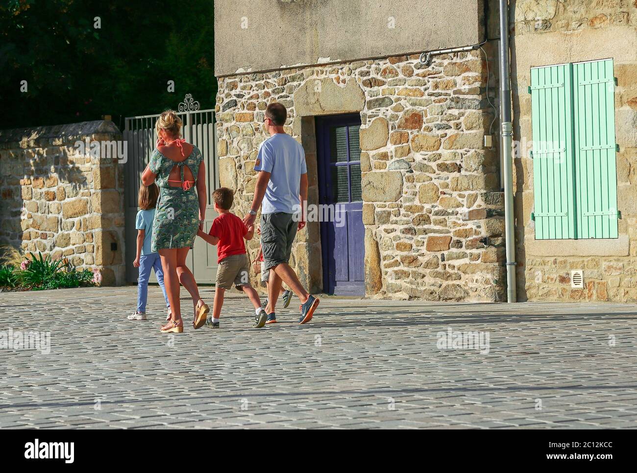 Happy young family having fun outside on the street of a village Stock ...