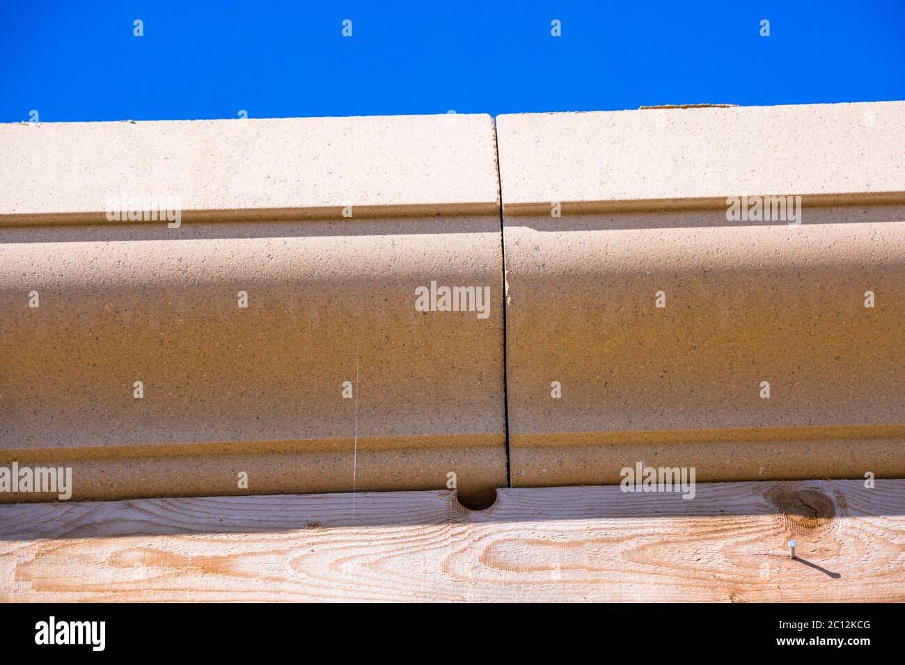 Close-up view of brown brick blocks on top of brown wood Stock Photo ...