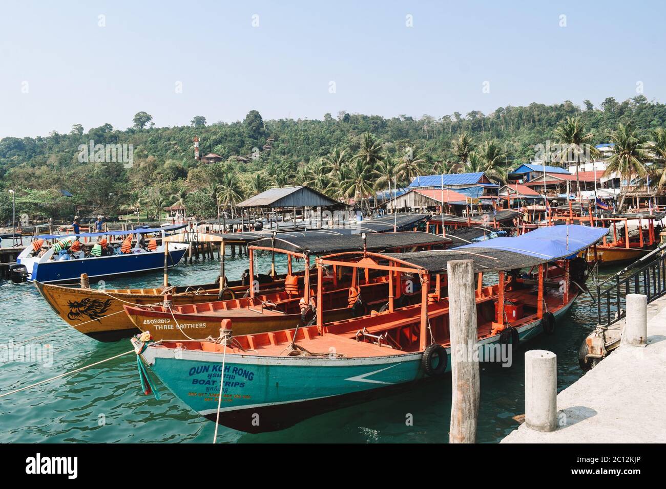 Boats docking by a pier in the port of Koh Rong Island in Cambodia ...