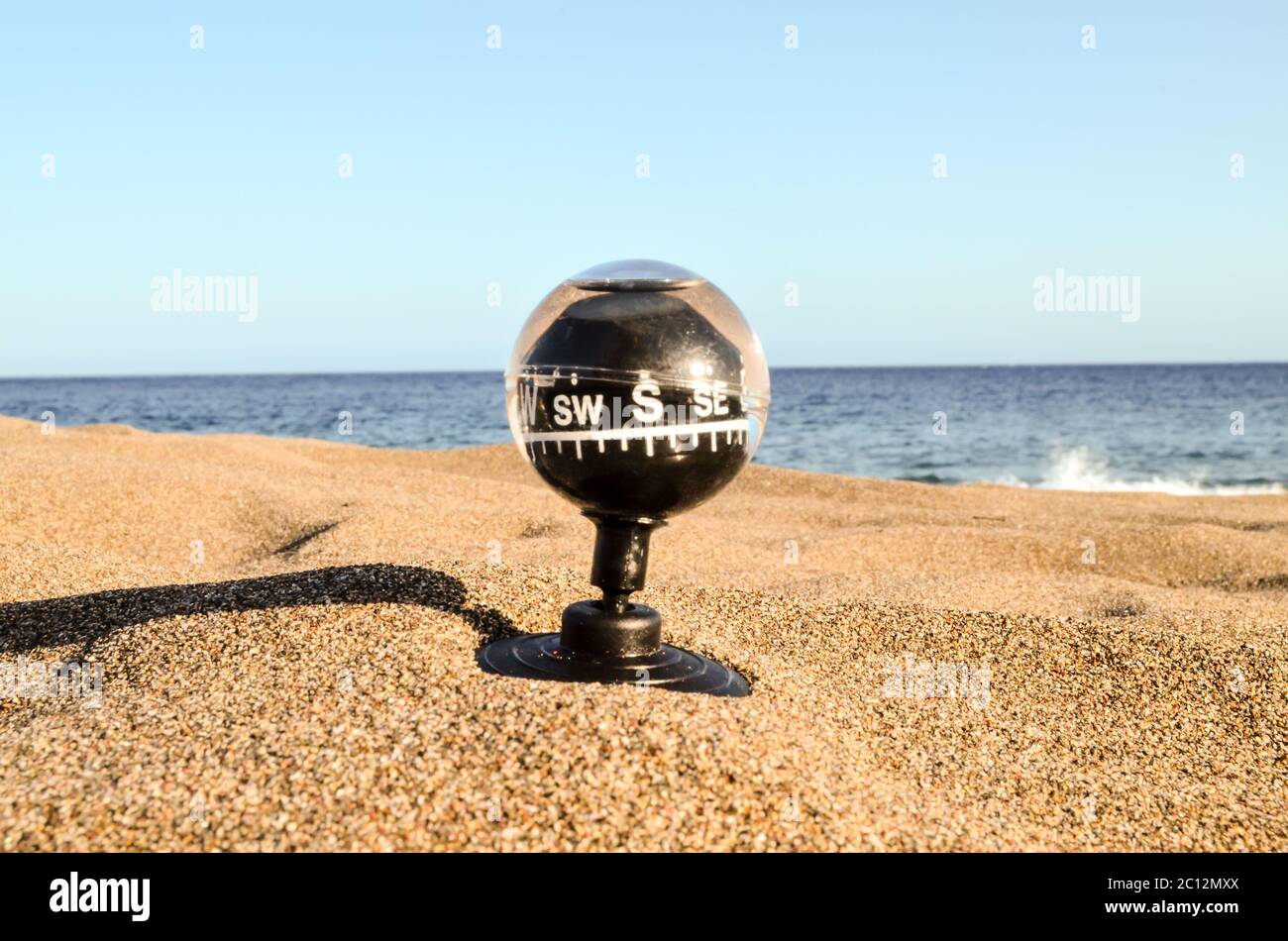Compass on the Sand Beach Stock Photo - Alamy