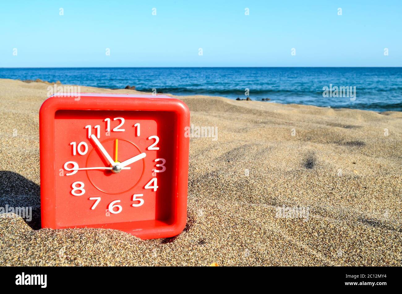 Clock on the Sand Beach Stock Photo - Alamy