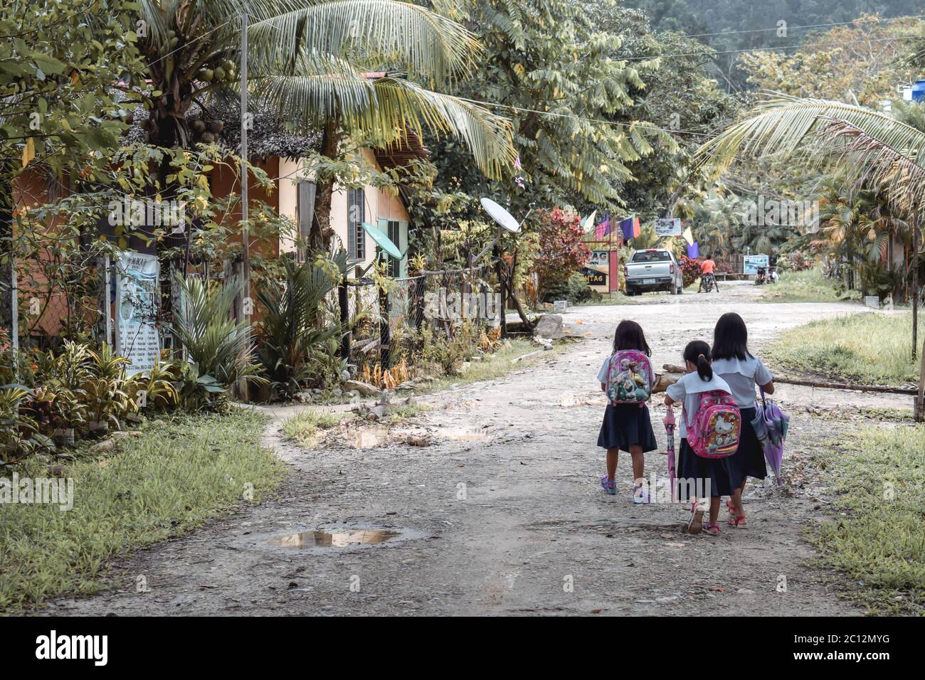 Three little Philipine Pinoy schoolgirls walking back home from school ...