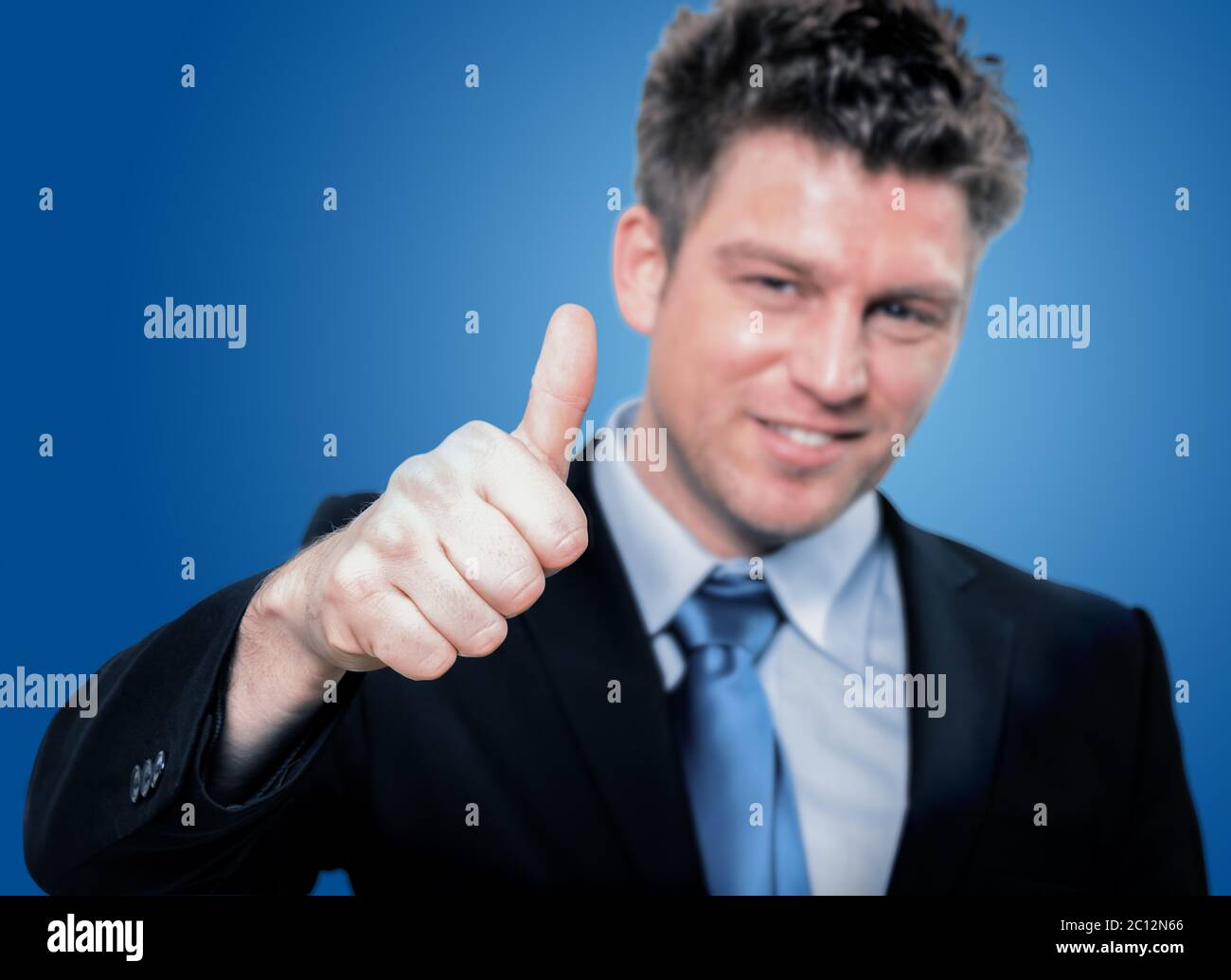 Happy handsome business man holding thumbs up Stock Photo - Alamy
