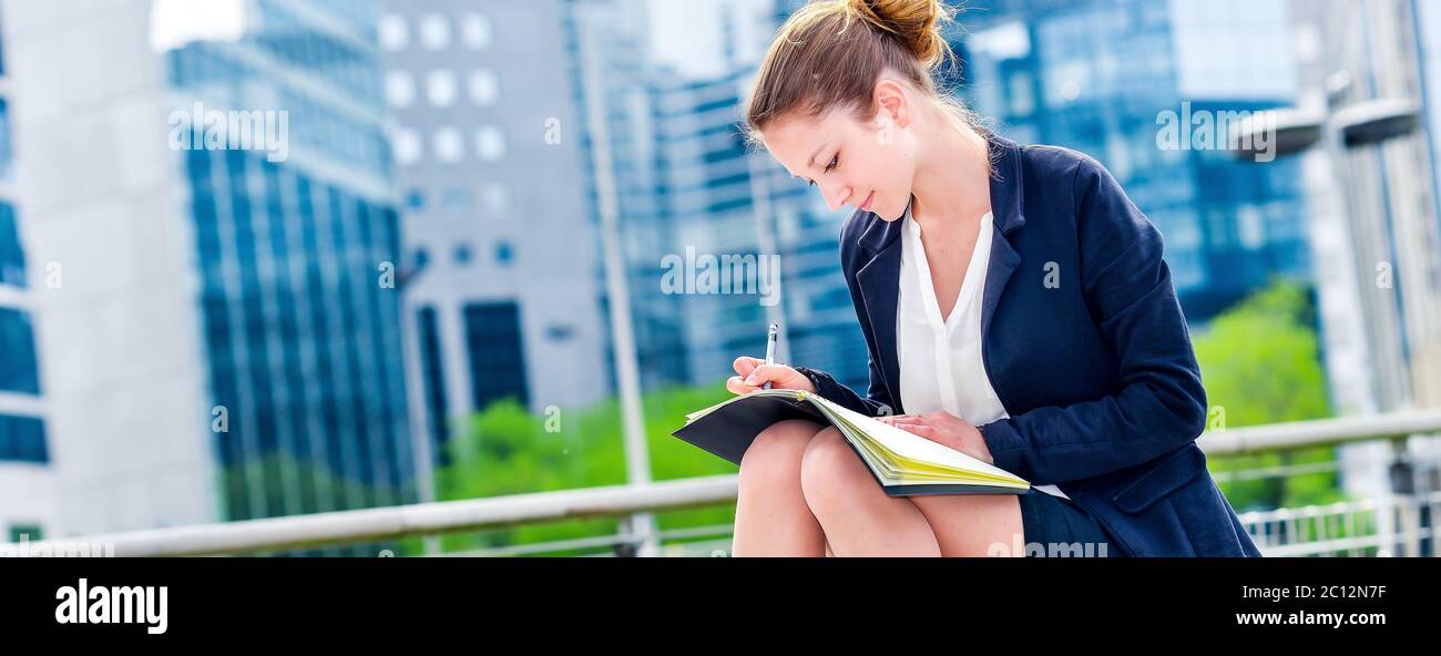 dynamic young executive taking notes on her agenda Stock Photo - Alamy