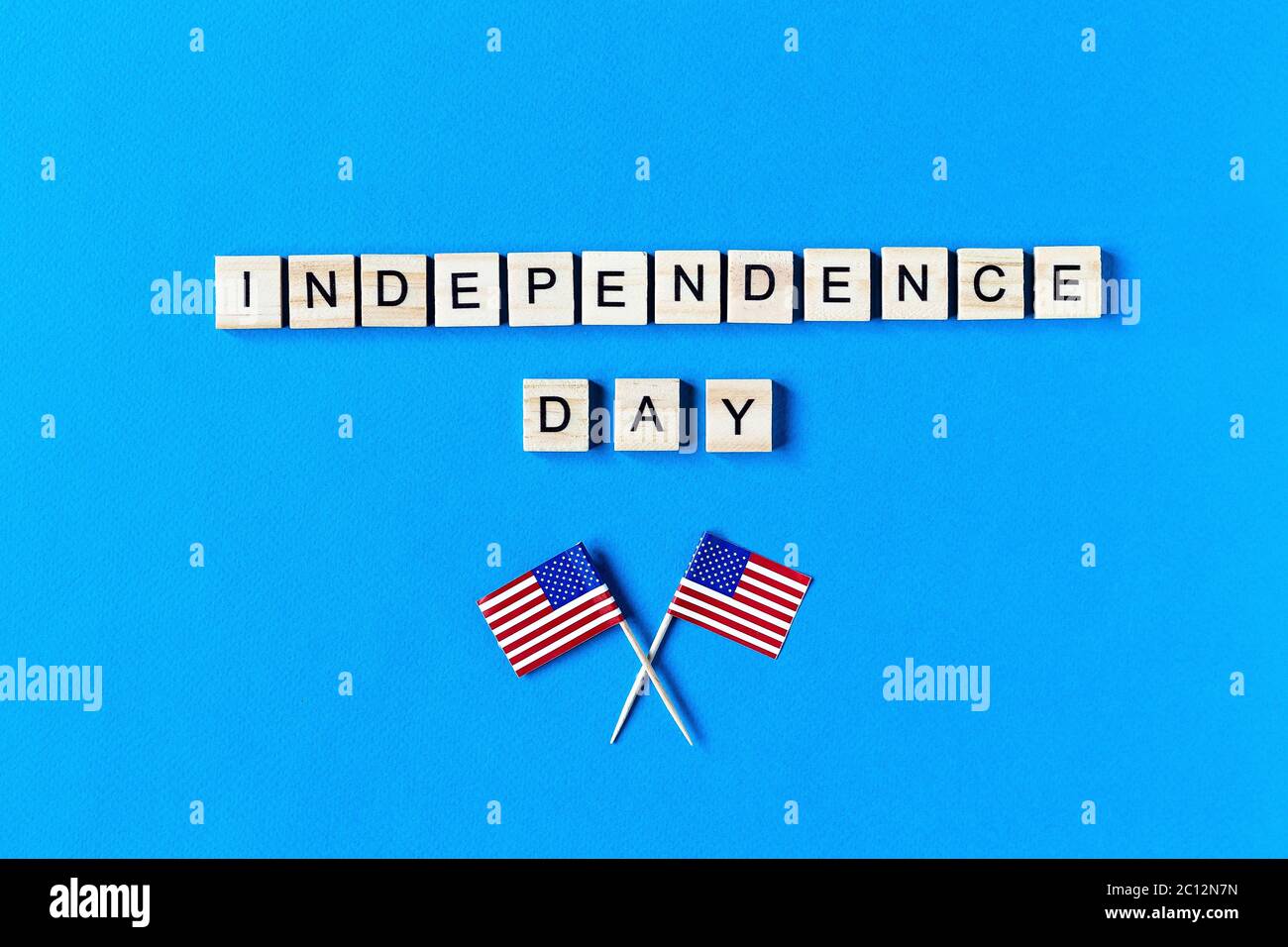 Independence Day inscription in wooden letters on a blue background ...