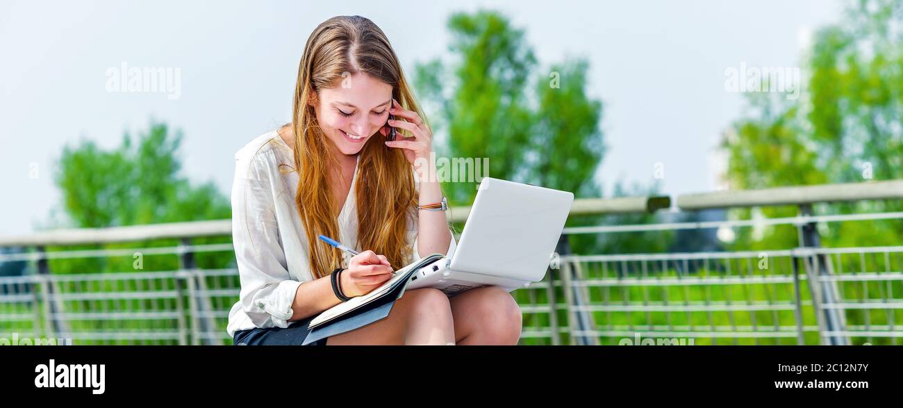 dynamic young executive taking notes on her agenda Stock Photo - Alamy