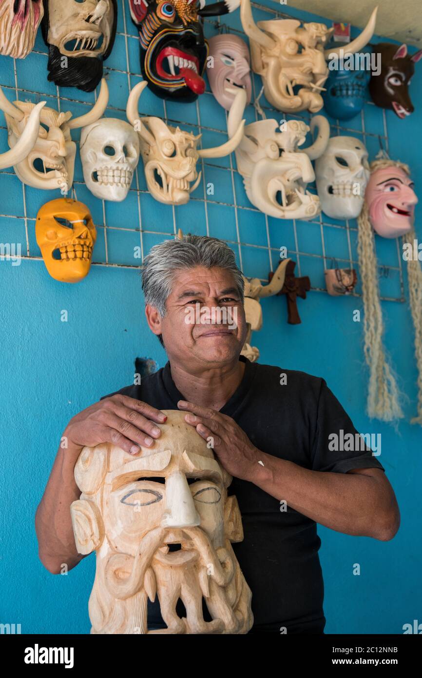 Wood working artist Felipe Horta holds a traditional Purepecha mask ...