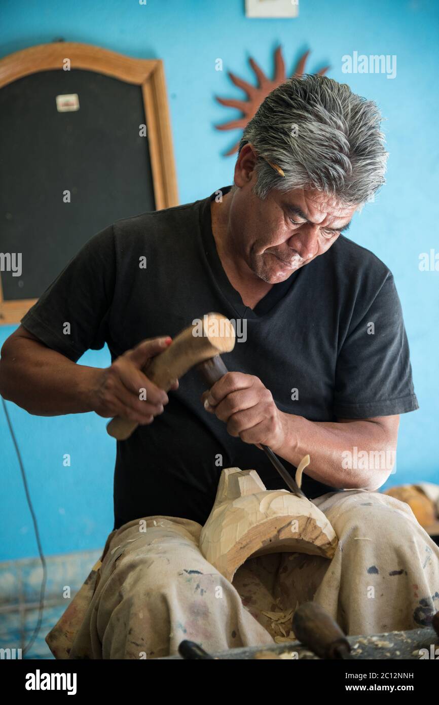Wood carver artist Felipe Horta works crafting a traditional Purepecha ...