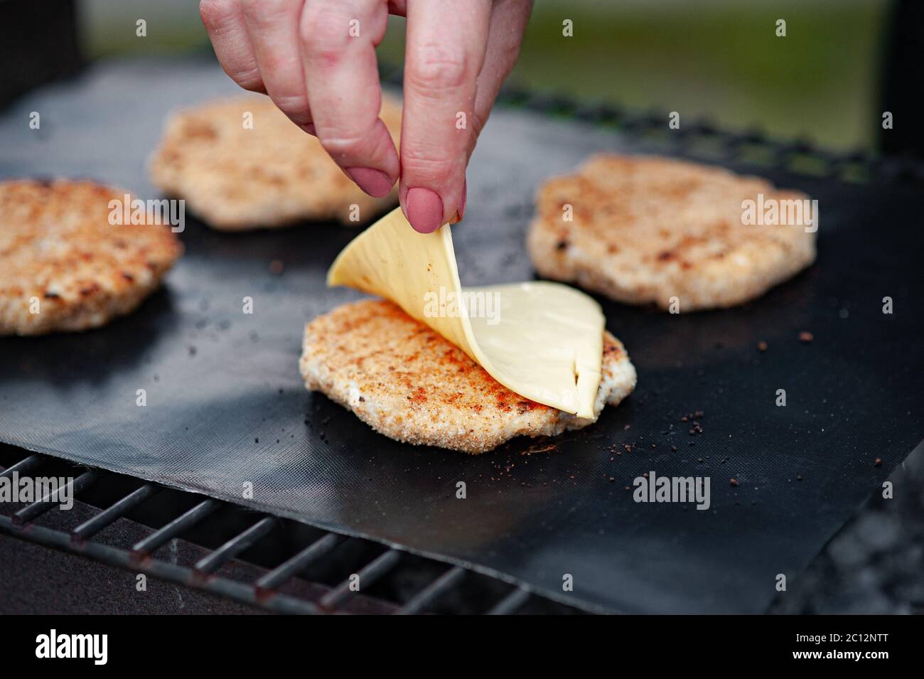 Putting cheese on a cutlet. Grilled Burger Cutlet Stock Photo - Alamy