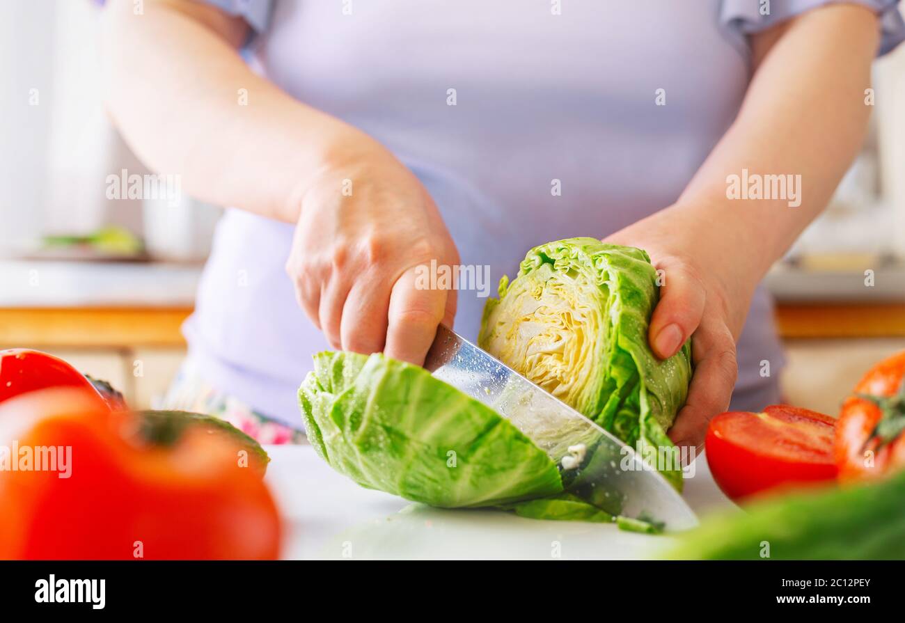 Chef slicing vegetables and cabbage on the table in restaurant. Process ...