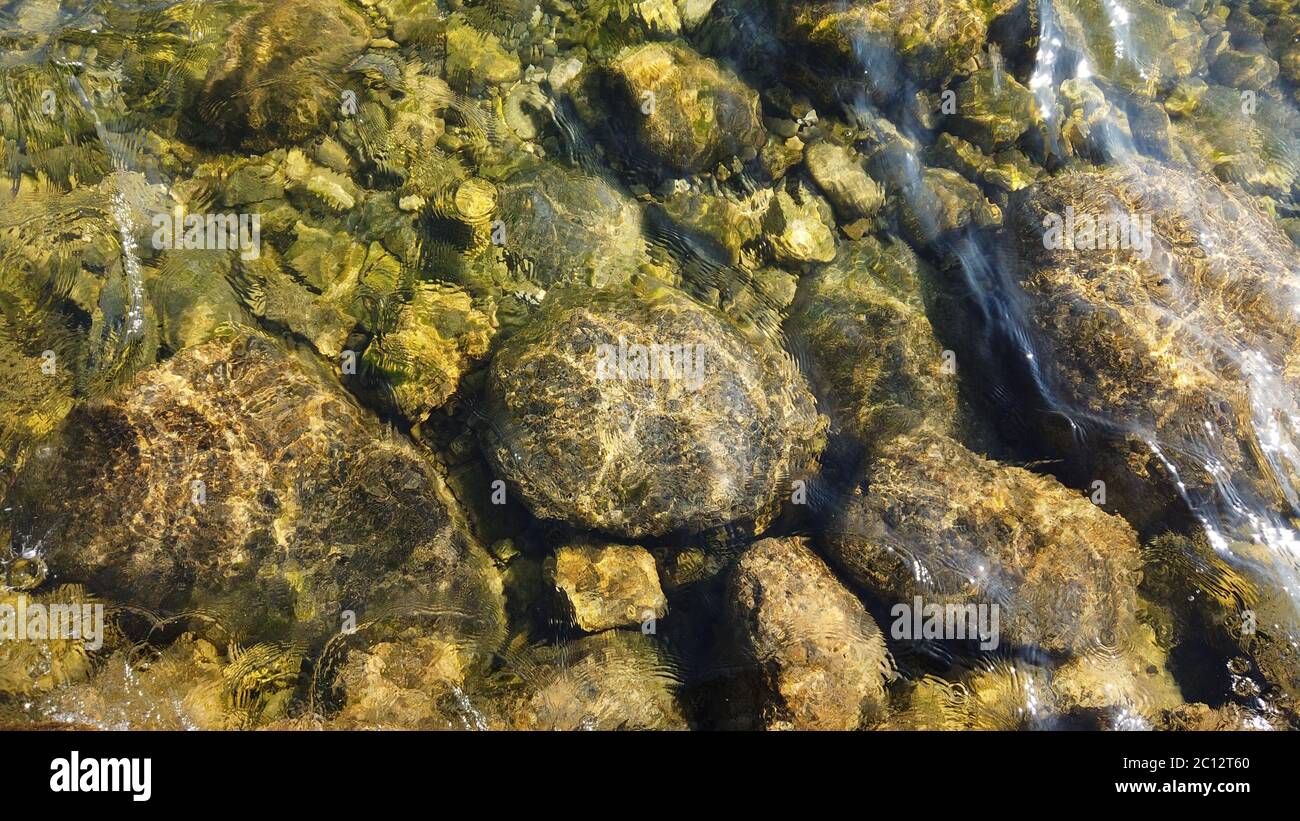 Water textures showing stones in the water Stock Photo - Alamy