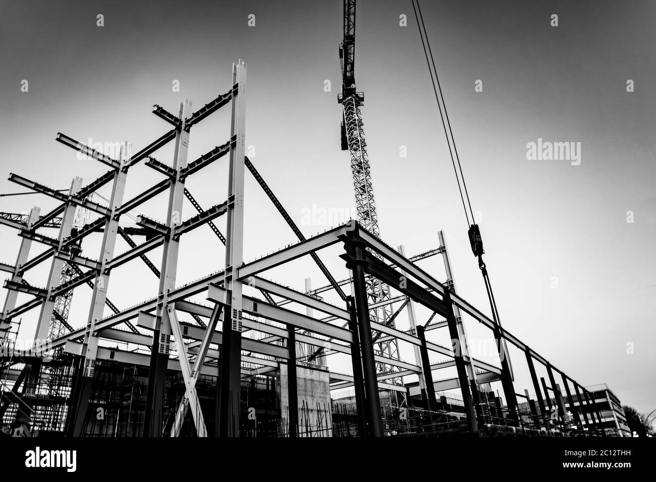 Gritty construction image of steel framing and construction crane on ...