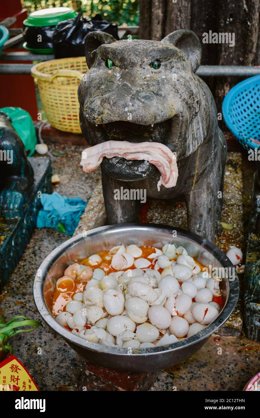 Statue of a tiger with ham and eggs as sacrificial gifts from ...