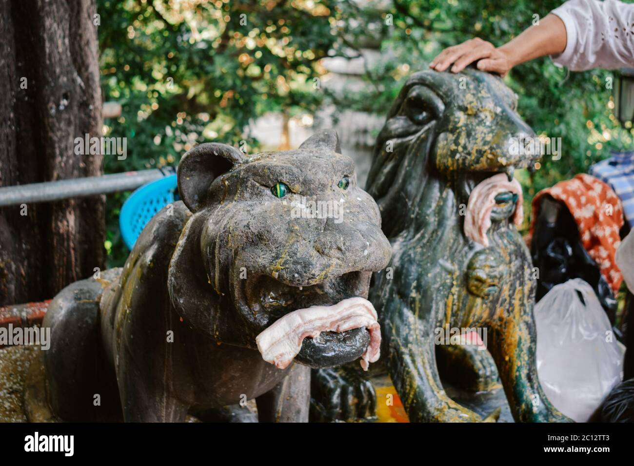 Tiger and lion statues with ham sacrificial gifts from worshipers in ...