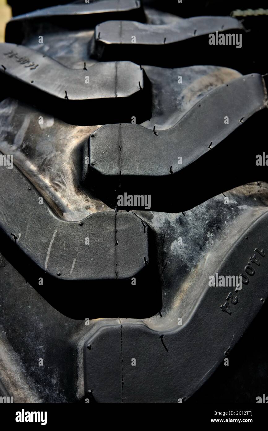 Closeup of a heavy duty truck tire with a deep, aggressive tread ...