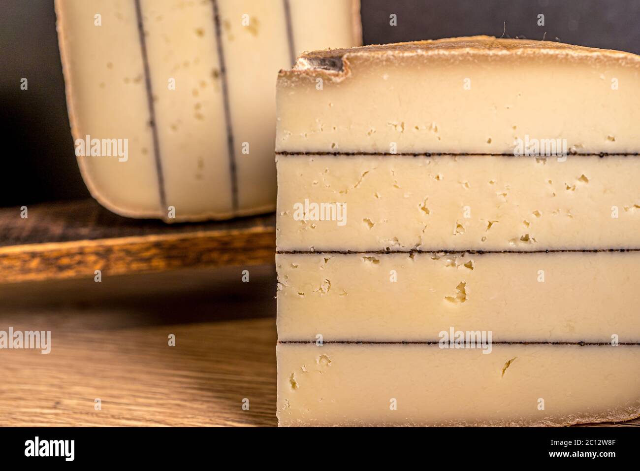 Cheese with truffles in the wooden background. Macro closeup. Delicious ...