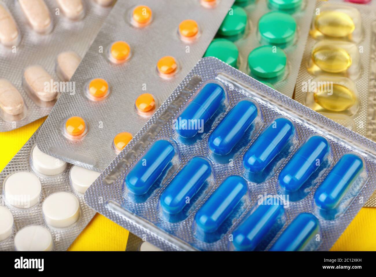group of multi-colored pharmaceutical medication and medicine pills in ...