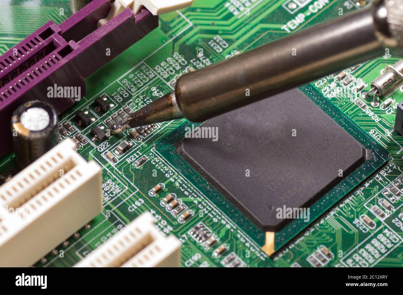 Technician repairing electronic circuit board with soldering iron Stock Photo - Alamy