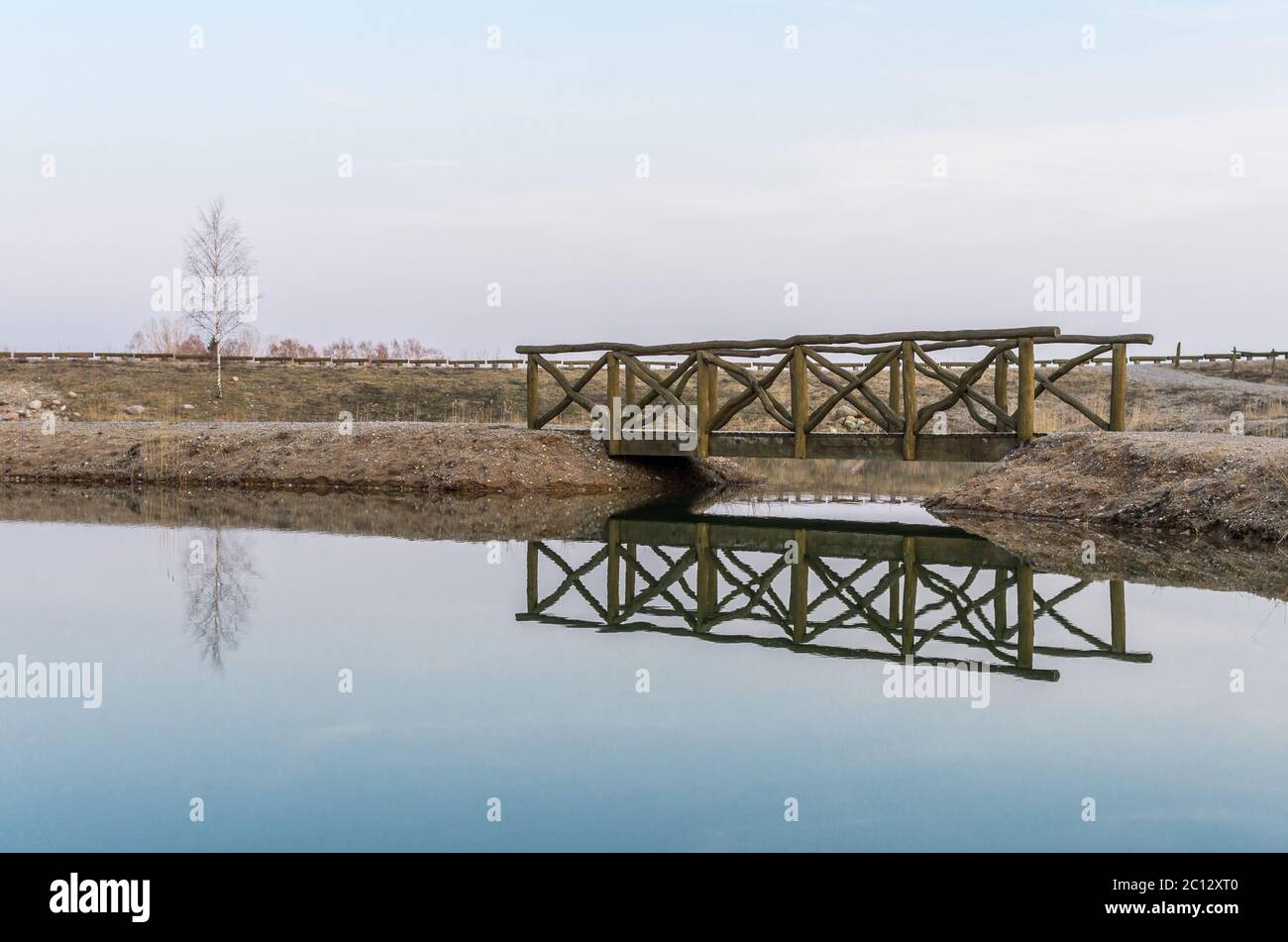Bridge reflection in water. Early spring evening Stock Photo - Alamy