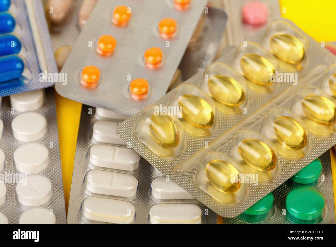group of multi-colored pharmaceutical medication and medicine pills in ...