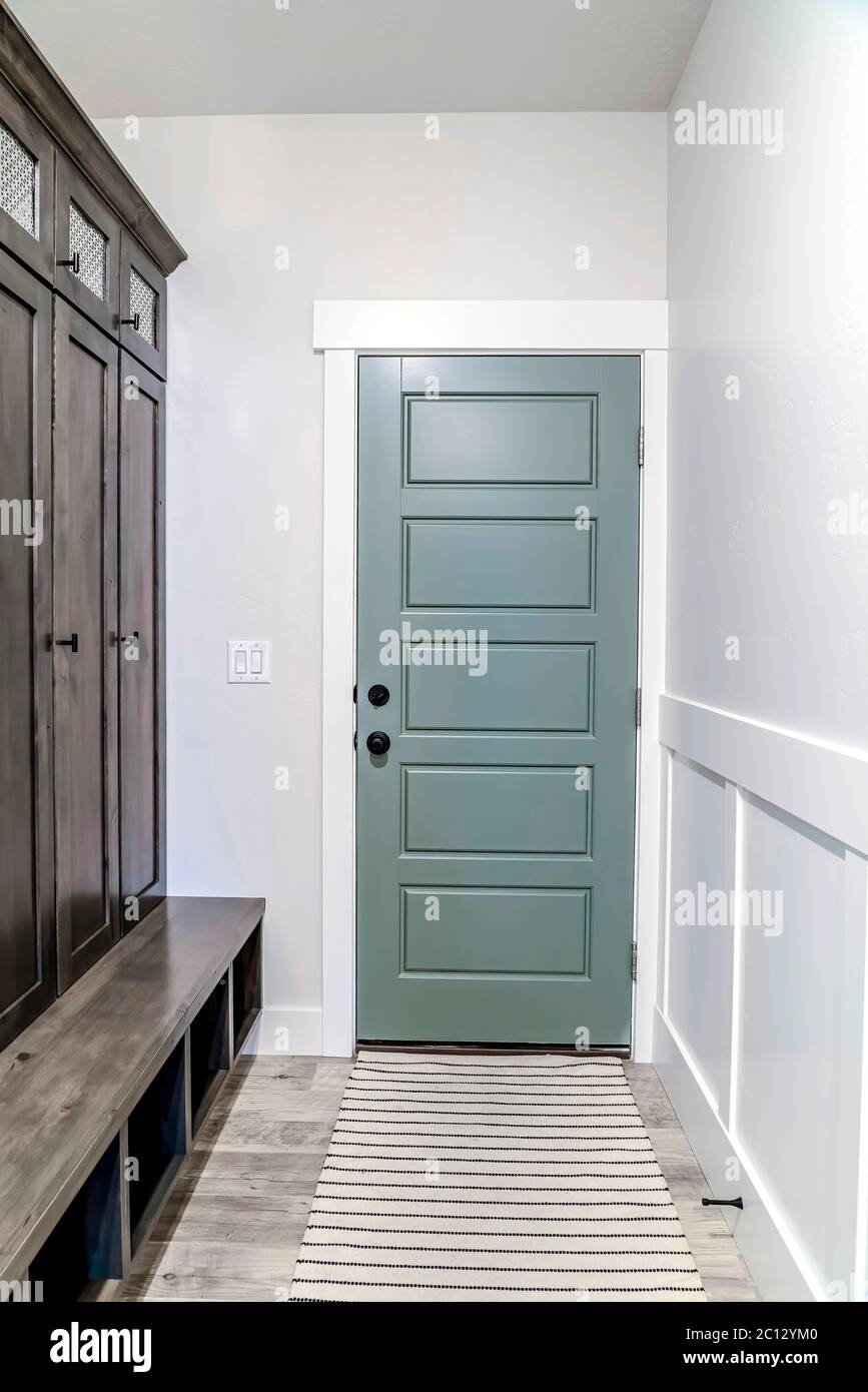 Hallway with runner rug on the floor that leads to the fire door of a ...