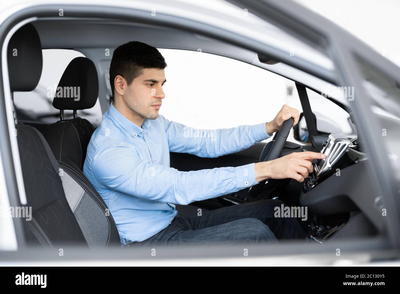 Young Businessman Sitting In New Auto Checking Dashboard Stock Photo ...