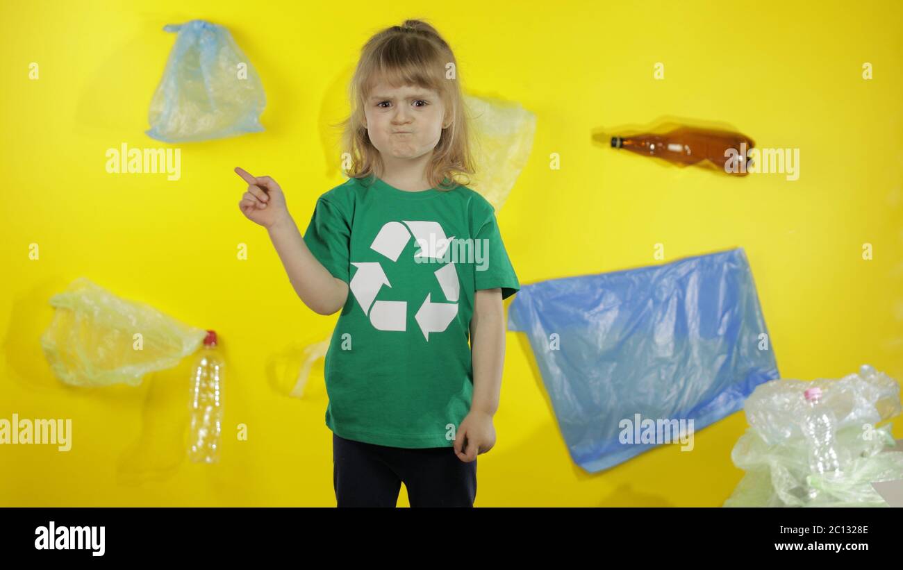 Girl activist volunteer in t-shirt with recycle logo asks not to litter ...