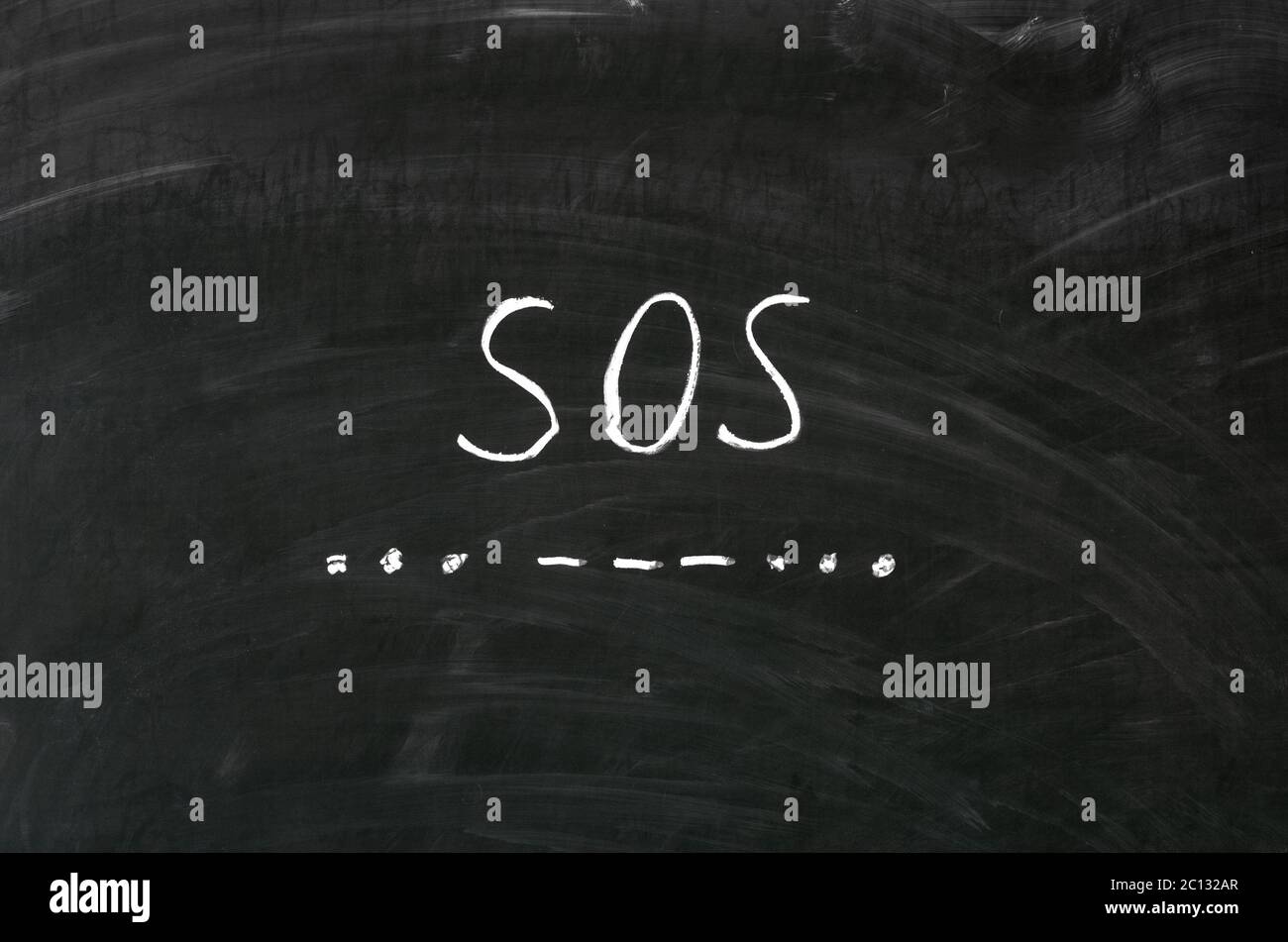 SOS word handwritten with white chalk on a blackboard Stock Photo - Alamy