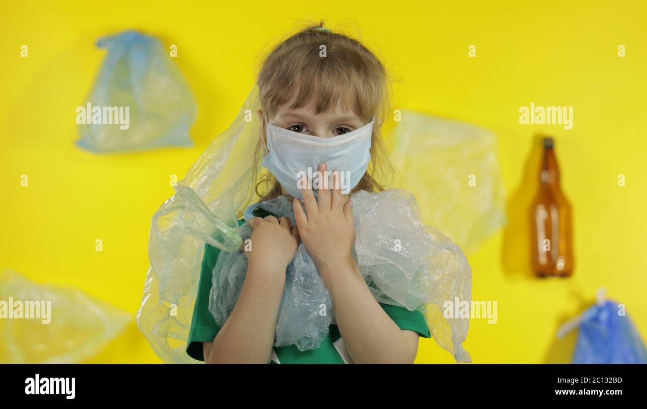 Sad girl activist in t-shirt with recycle logo in plastic packages on ...