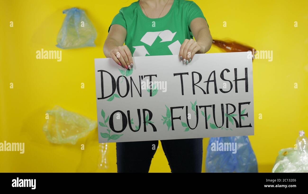 Unrecognizable woman activist in t-shirt with recycle logo holding ...
